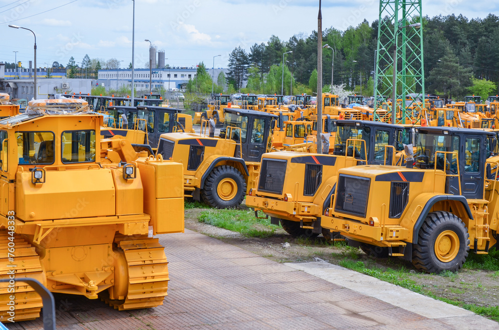 A storage yard with a lot of construction machines. Warehouse of ...