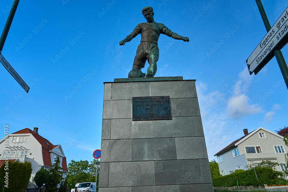 bronze statue of a football or soccer player at the stadium in ...