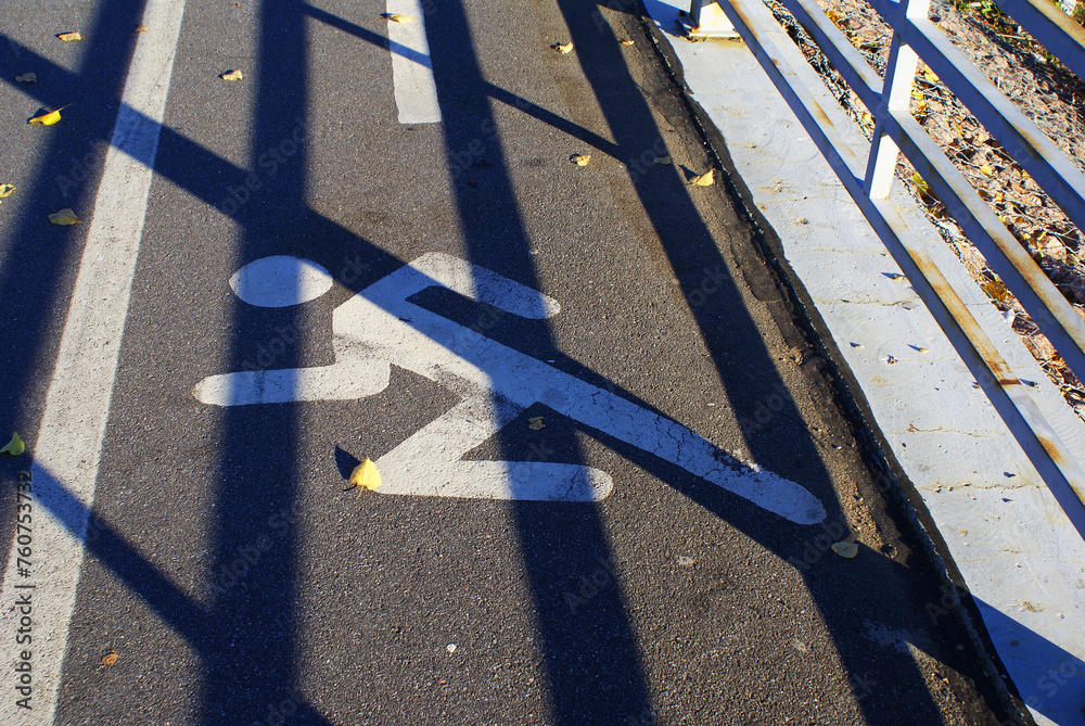 Road markings painted with white paint. Signs on the sidewalk and road ...