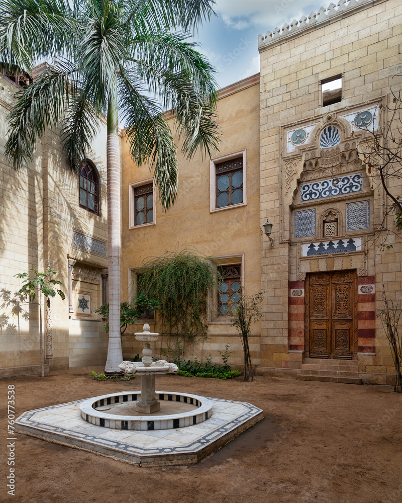 A tranquil courtyard with palm trees and marble fountain at Prince ...