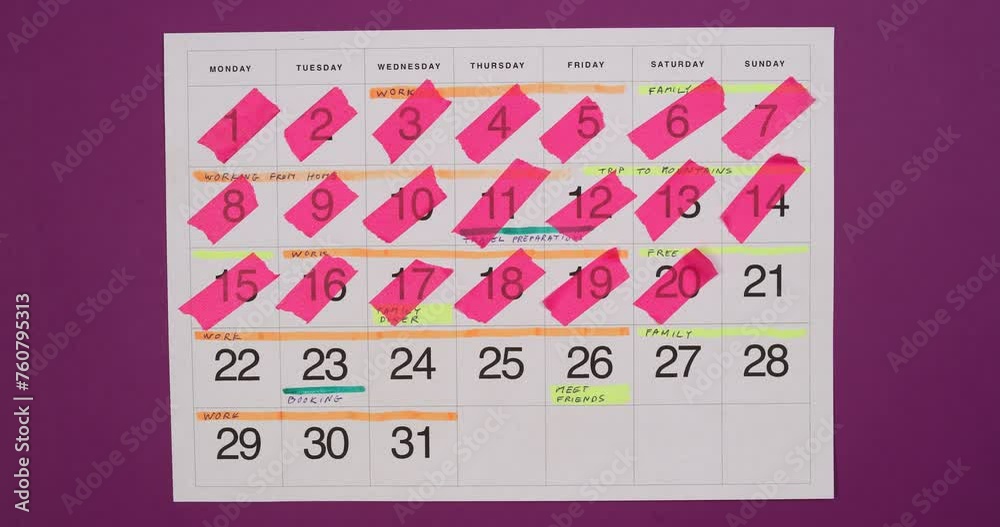 Monthly calendar planning with colorful highligted notes and reminders ...