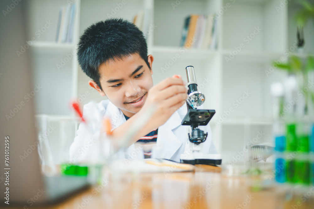 Asian male science students looking through a microscope and tests of ...