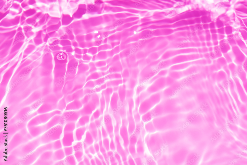 Pink water bubbles on the surface ripples. Defocus blurred transparent ...