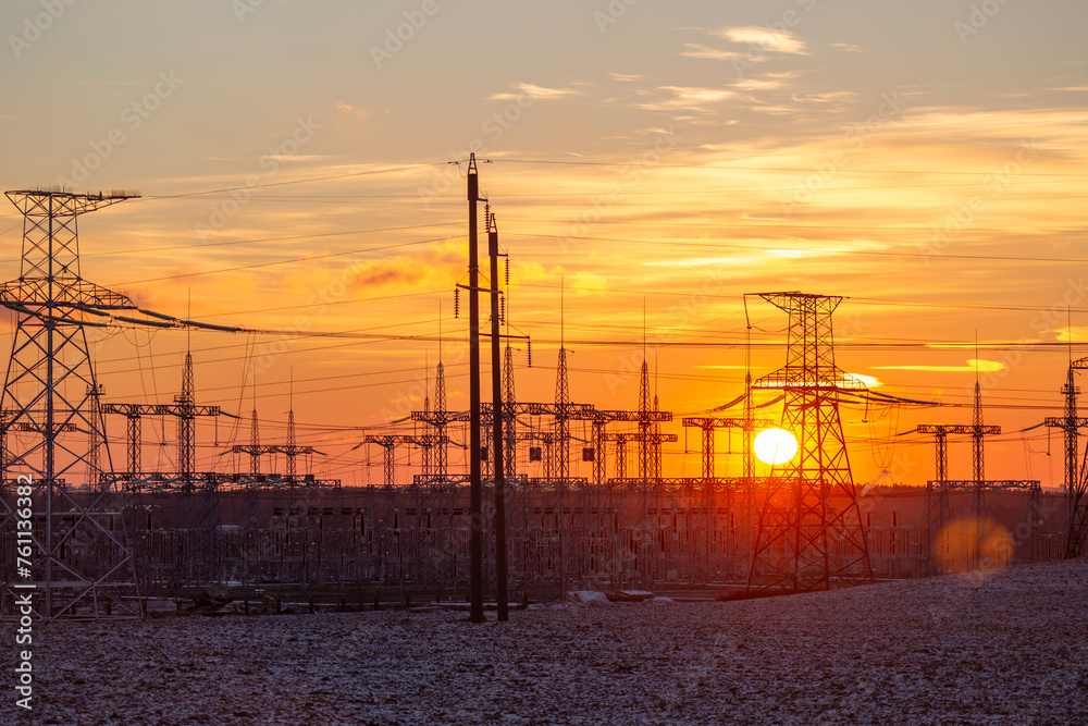 High-voltage direct current line Power lines at sunset, sun rays. High ...