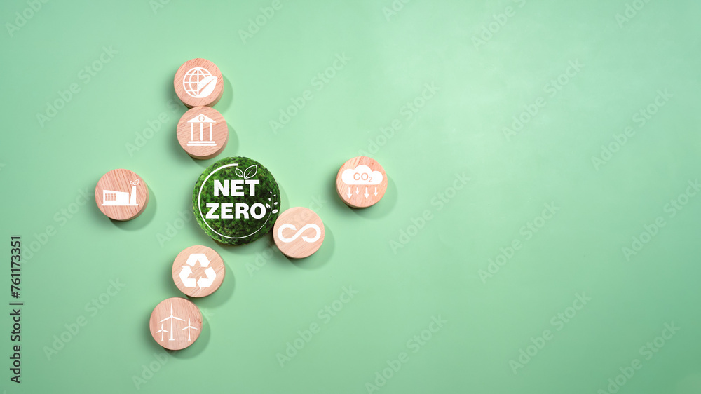 Circular wooden board with net zero icon in 2050 on green background ...