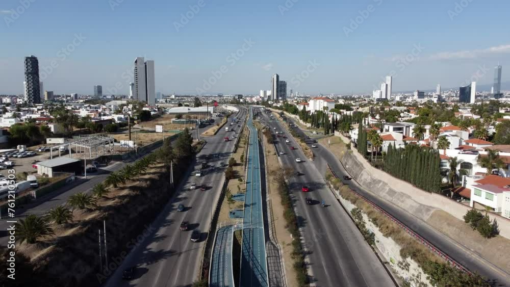 Slow forward flight above Mexican highway with traffic in Puebla City ...