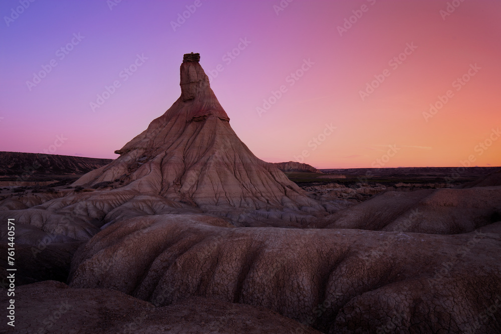 Captivating twilight colors paint the sky above a striking badlands ...
