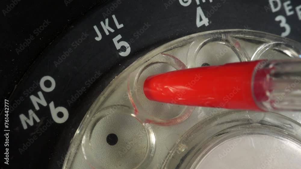 Making a telephone call on a rotary dial landline telephone. Close up ...
