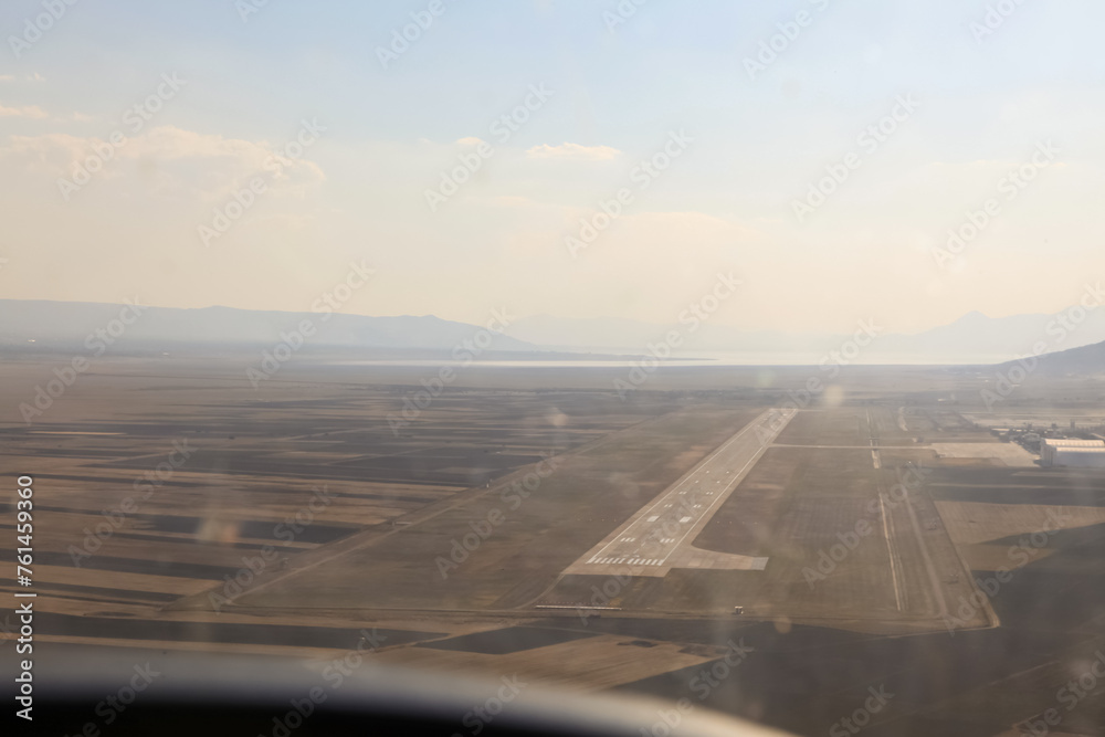 Cockpit view of the plane landing on the runway at a small airport ...