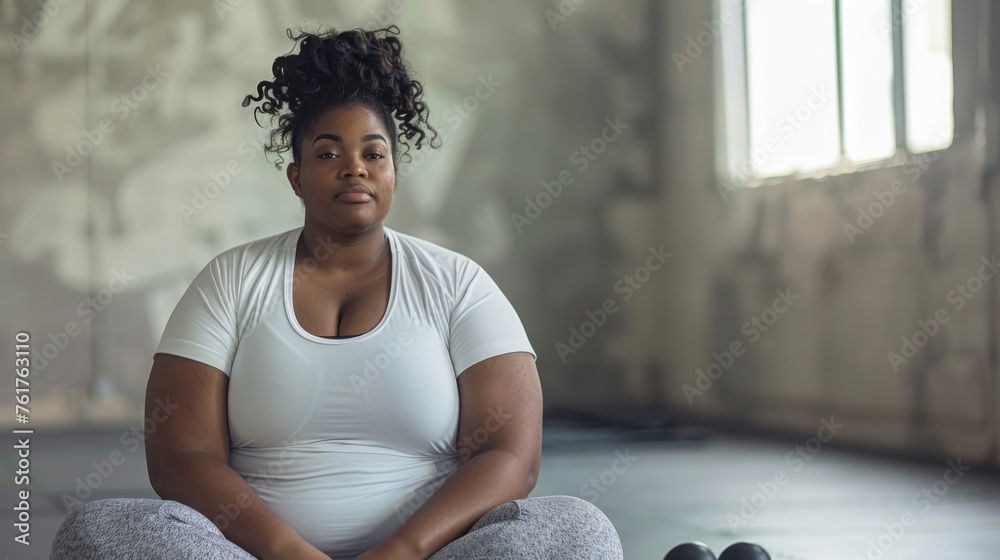 Fat body positive Black woman, wearing a white T-shirt and gray yoga ...