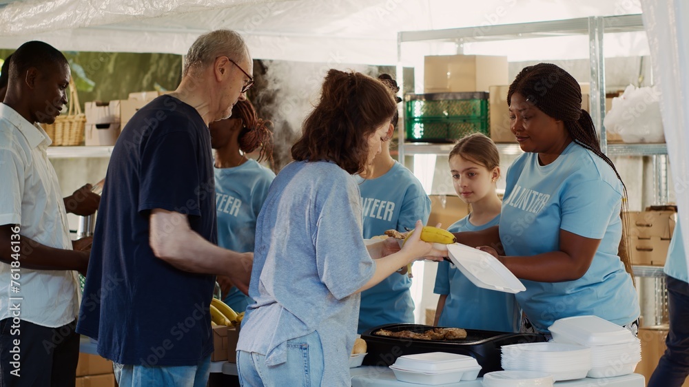 At a non-profit food drive event multicultural group of volunteers help ...