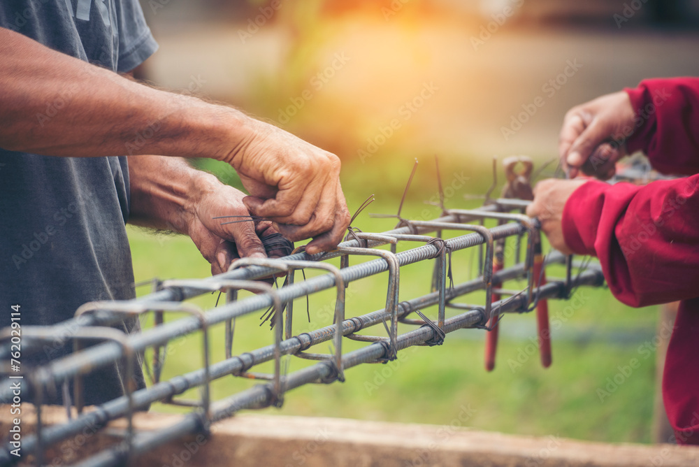 Construction Men hands bending cutting steel wire fences bar ...