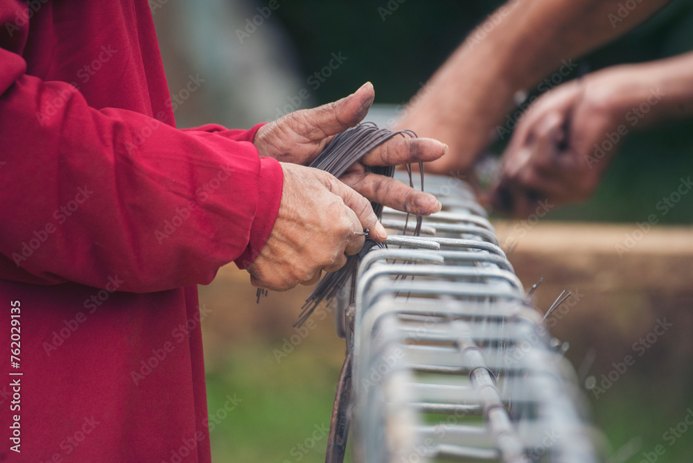 Construction Men hands bending cutting steel wire fences bar ...