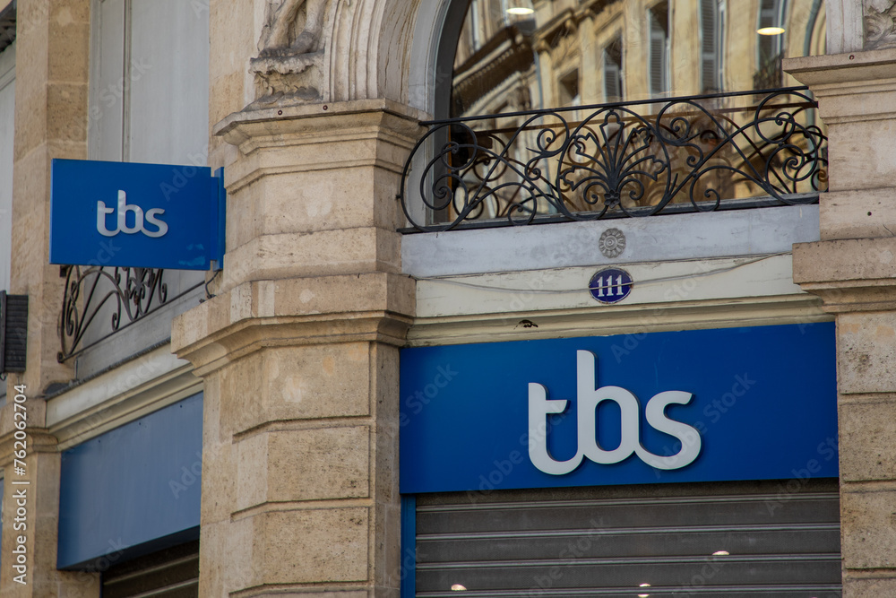 TBS sign logo and text brand front wall facade store fashion chain ...