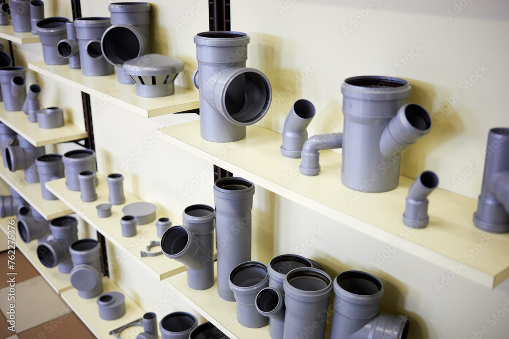 Fittings for plastic piping system on shelves. Stock Photo | Adobe Stock