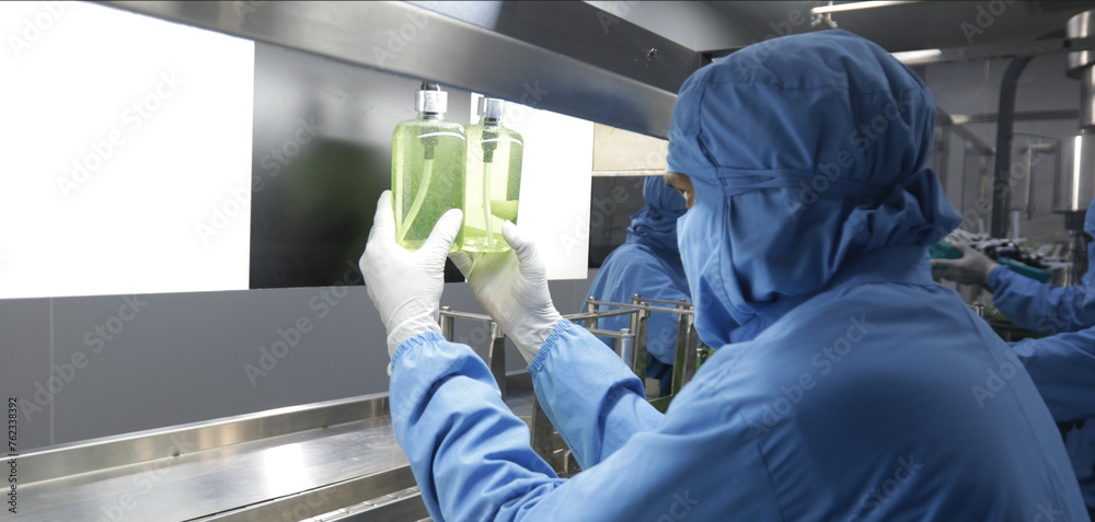 man doing visual inspection, chemical liquid sanitiser gel in bottles ...