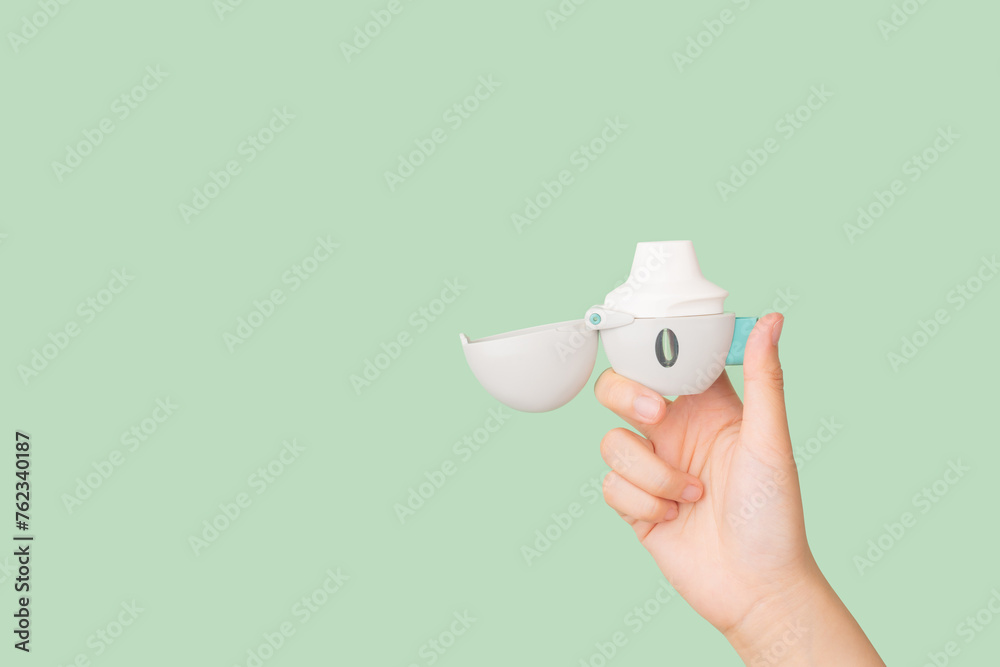 Asthma and COPD concept. Female hand holding Tiotropium bromide inhaler ...