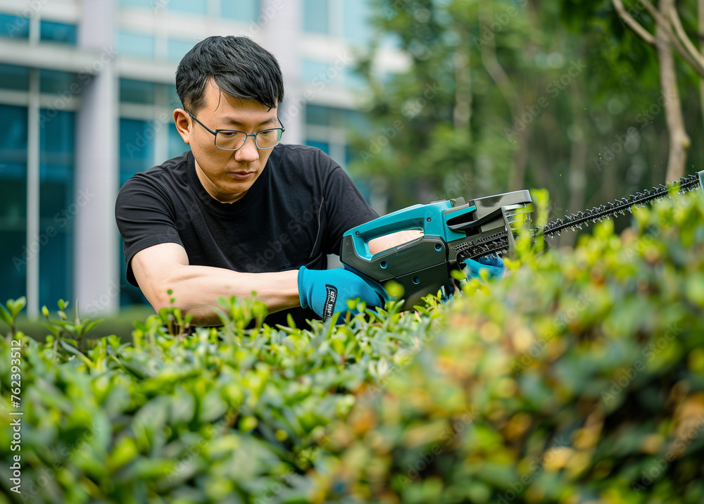 product photography of a man using powerful and imposing garden power ...