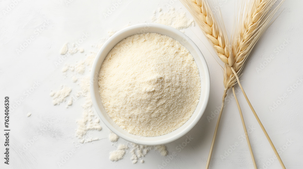 Raw semolina flour, also known as Rava powder, in a white bowl with two ...