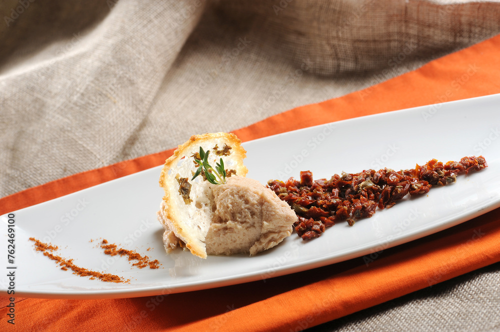 tuna quenelle with dried tomato pesto and caper bread wafer Stock Photo ...