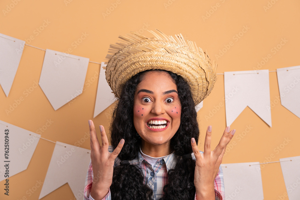 excited afro brazilian woman to Festa Junina in Brazil in beige studio ...