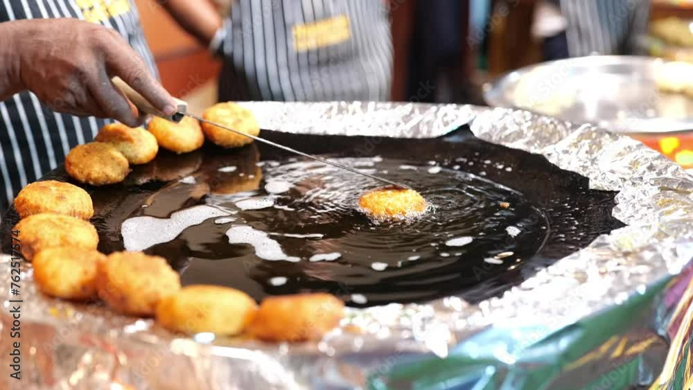 Aloo tikki being beep fried in a pan , also known as aloo ki tikkia ...