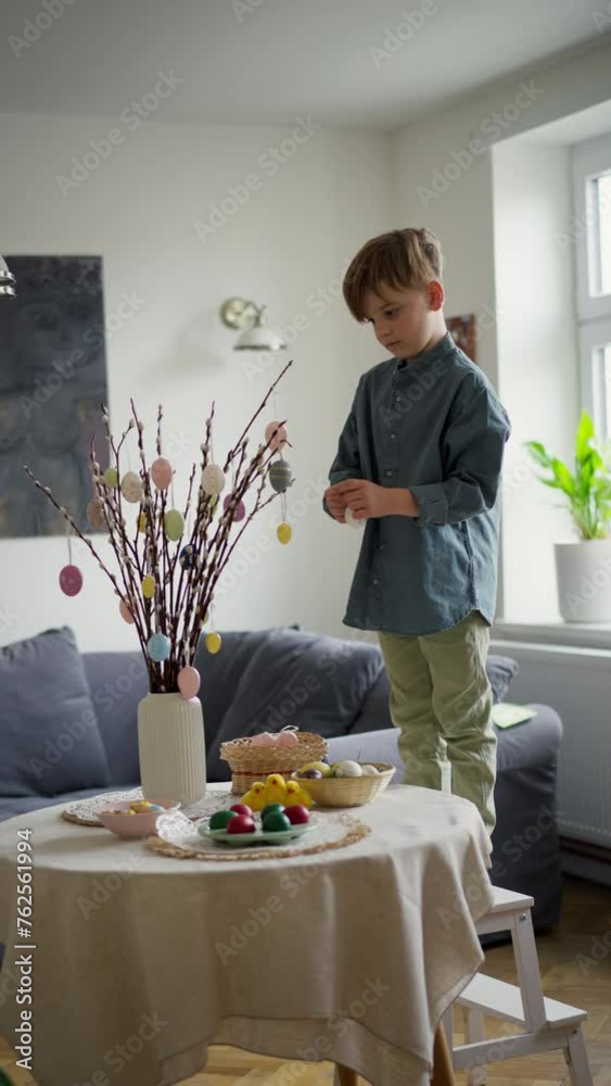 Little boy setting table for traditional easter lunch. Recreating ...