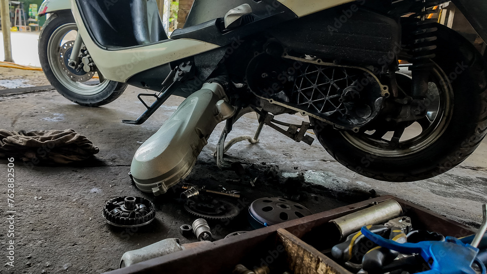 Motorcycle repair concept: Close-up view of a scooter with disassembled ...