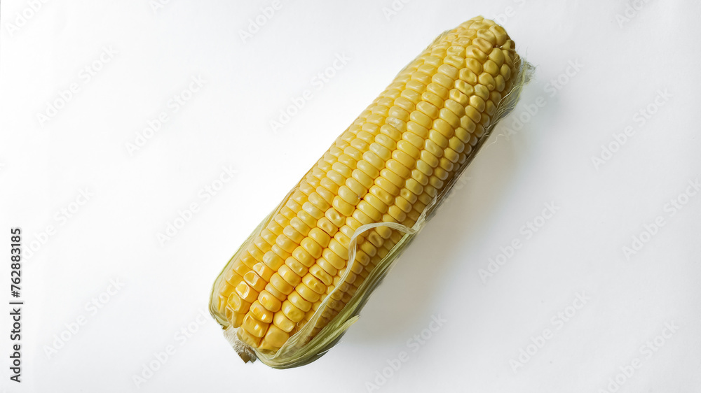 Fresh whole corn cob with husk on a white background with space for ...