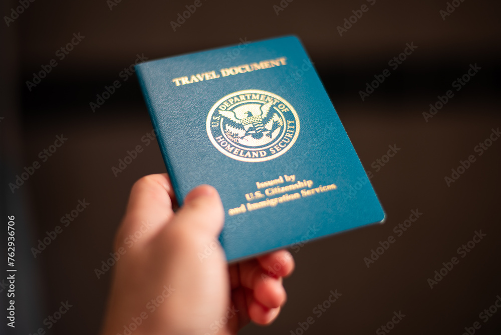 USA Re-entry Permit holding in hand with soft background and shallow ...