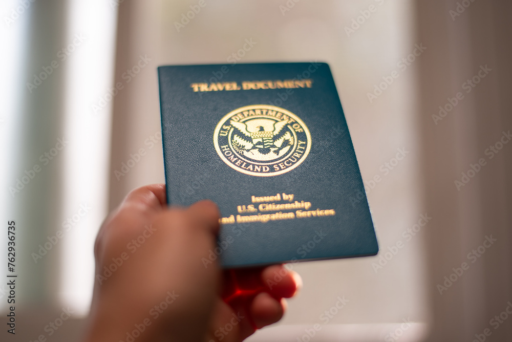 USA Re-entry Permit holding in hand with soft background and shallow ...
