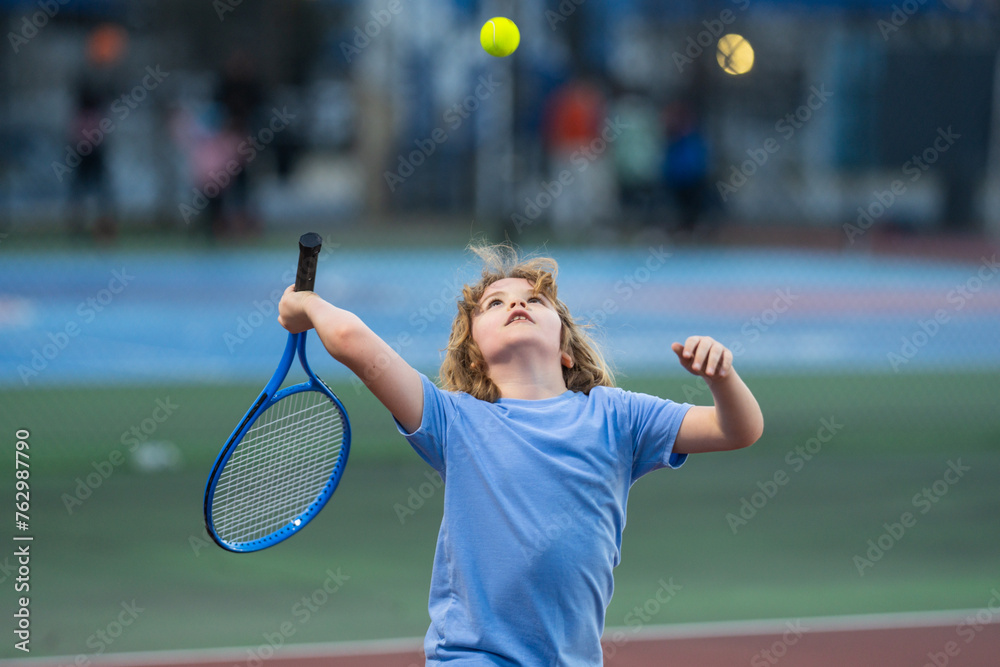 Kid playing tennis on court. Child hit tennis ball with tennis racket ...