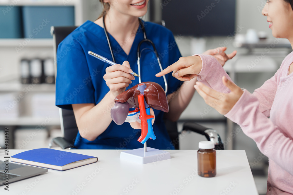 Caucasian liver professional female doctor explain to asian female ...