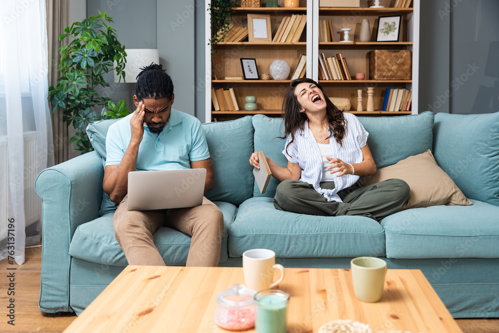 Simple living. Young couple man and woman at home working on laptop ...