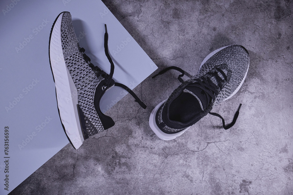 Grey sneakers isolated on a concrect background, seasonal shoes for ...
