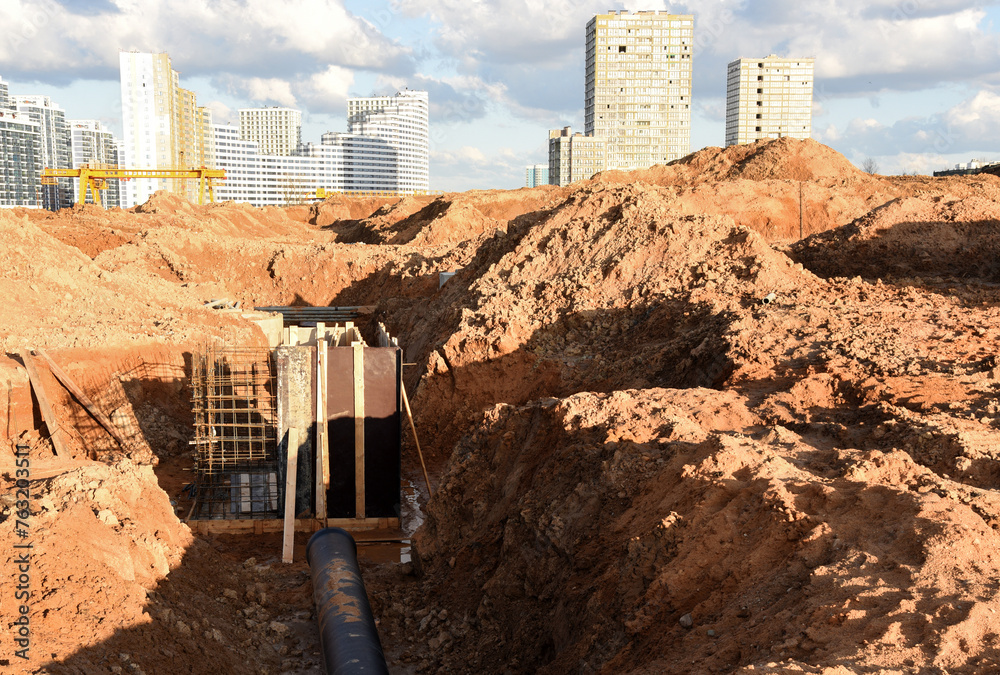 Laying of underground storm sewer pipes. Building construction on ...