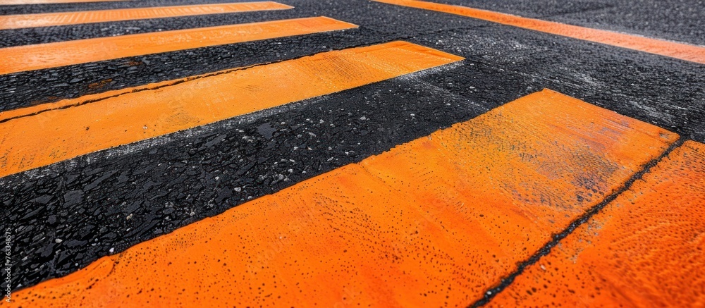 Detailed lines painted in orange and black on the street's surface ...