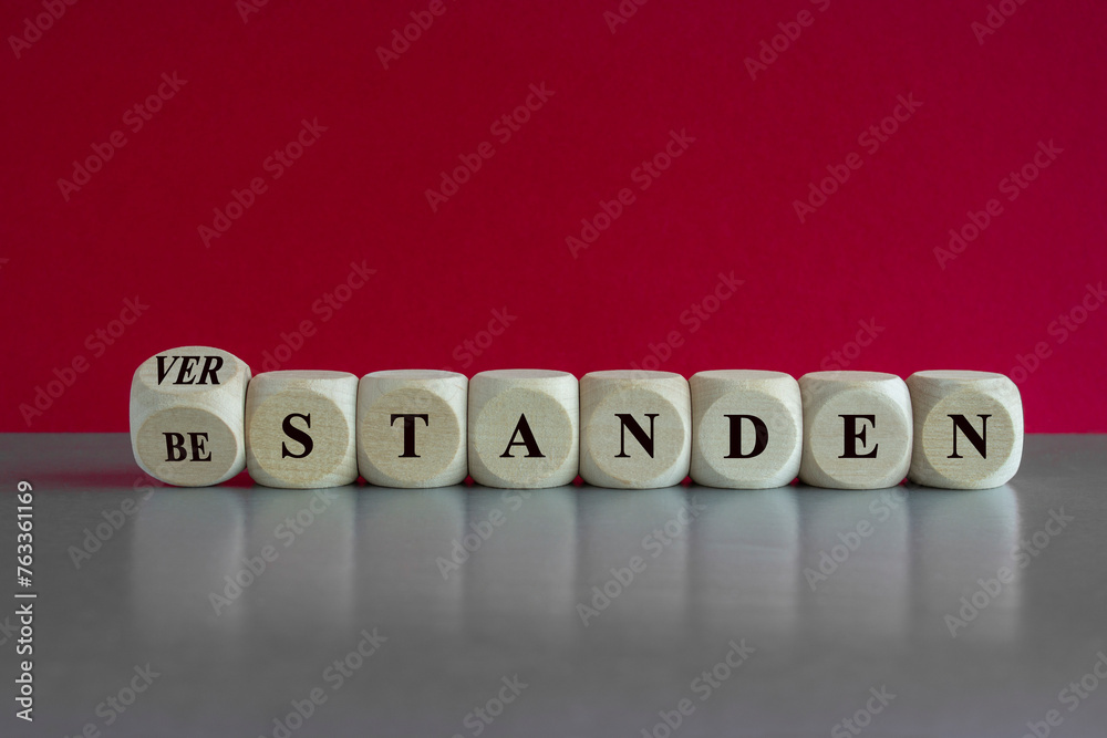 Turned a wooden cube and changes the German word bestanden (passed) to ...