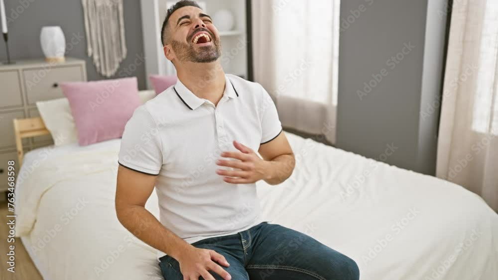 Laugh out loud! young, handsome hispanic man, full of joy, sitting on ...