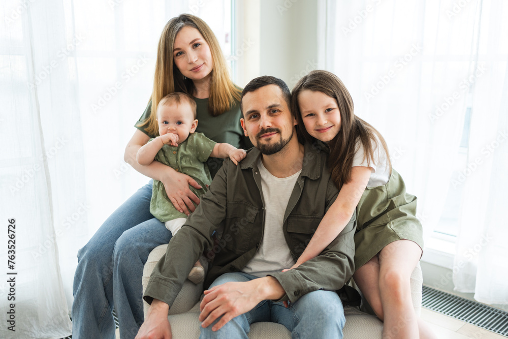 Happy family at home. Mother father two children daughters relaxing ...