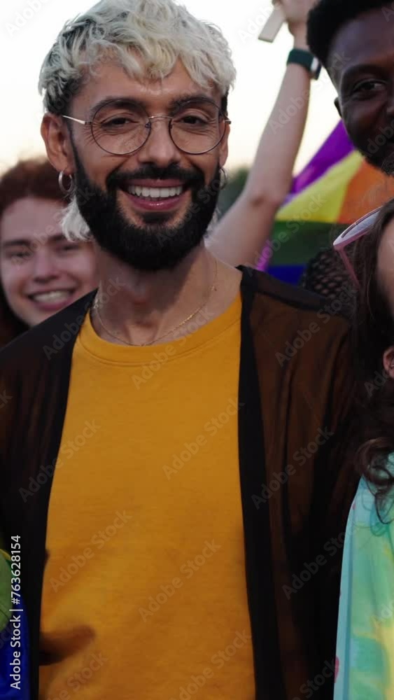 Vertical group of people are standing next to each other holding ...