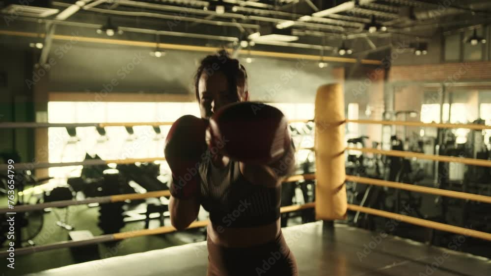 A female boxer channels intensity and precision as she throws direct ...