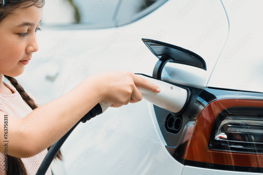 Little young girl learn about eco-friendly and energy sustainability as ...