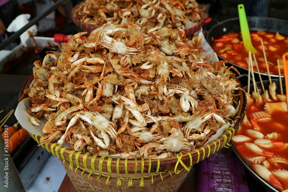 Stack of fried baby crabs display on the food stall in Indonesian ...
