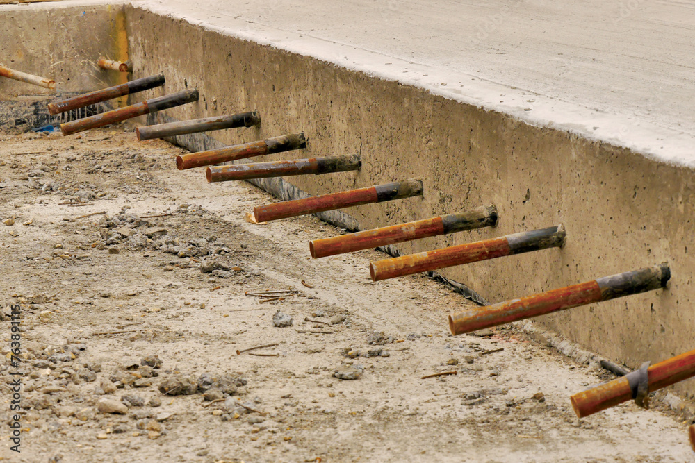 concrete slab edge showing steel dowel bars in a row. Stock Photo ...