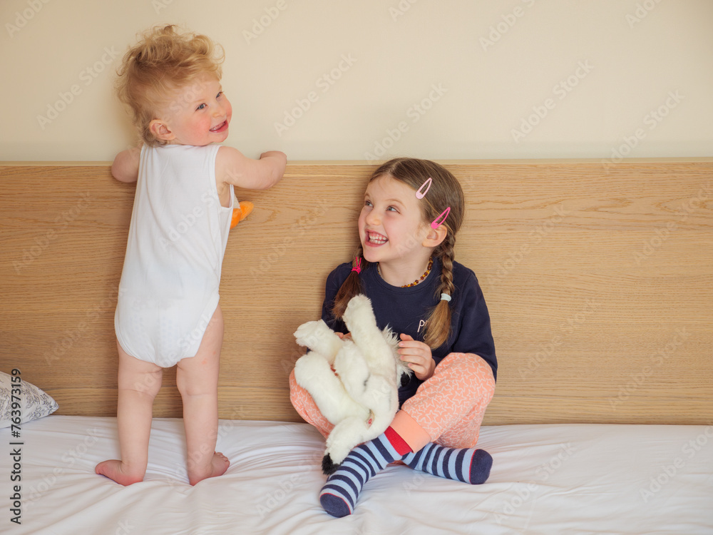 Little baby brother and his big sister siblings having fun together as ...