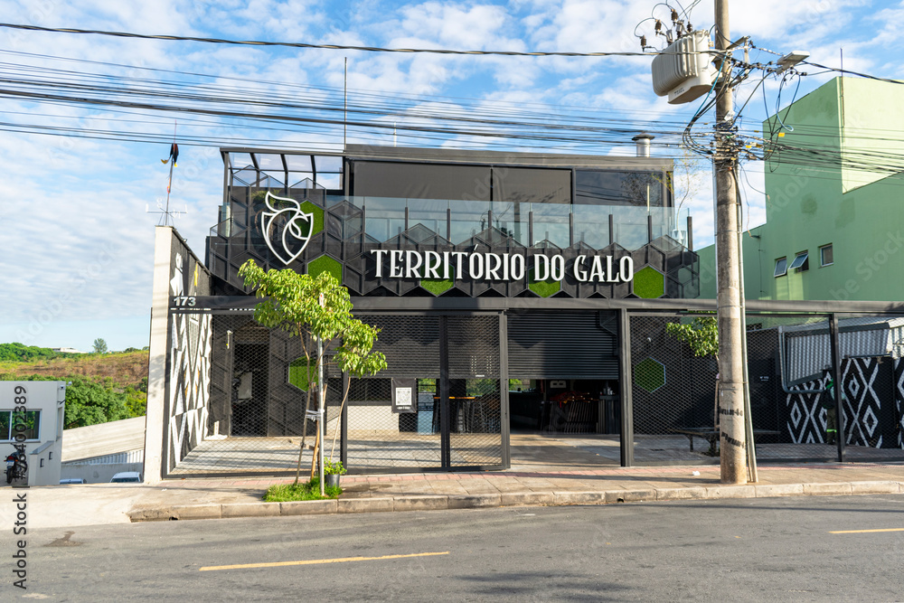 Commercial store. Power poles. Blue sky with clouds. Tree. Território ...