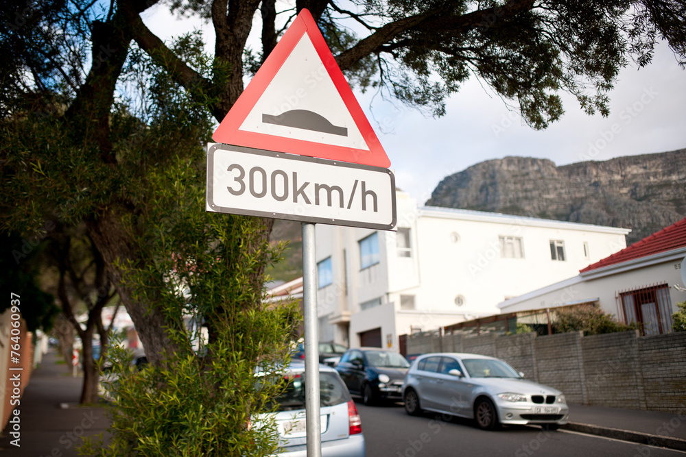 Road sign, warning and red triangle signage in street for speedbump ...
