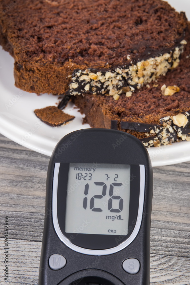 Glucose meter with high result sugar level, sweet chocolate cake ...