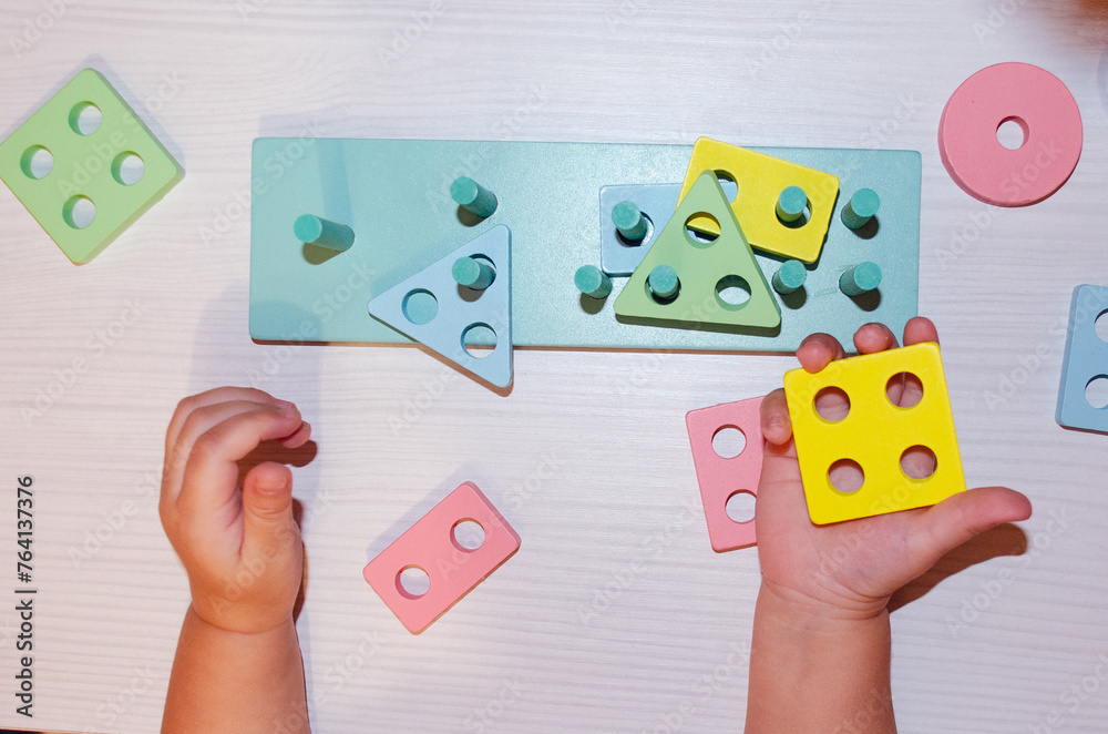 Child hand playing wooden educational teaching aids Intelligence game ...